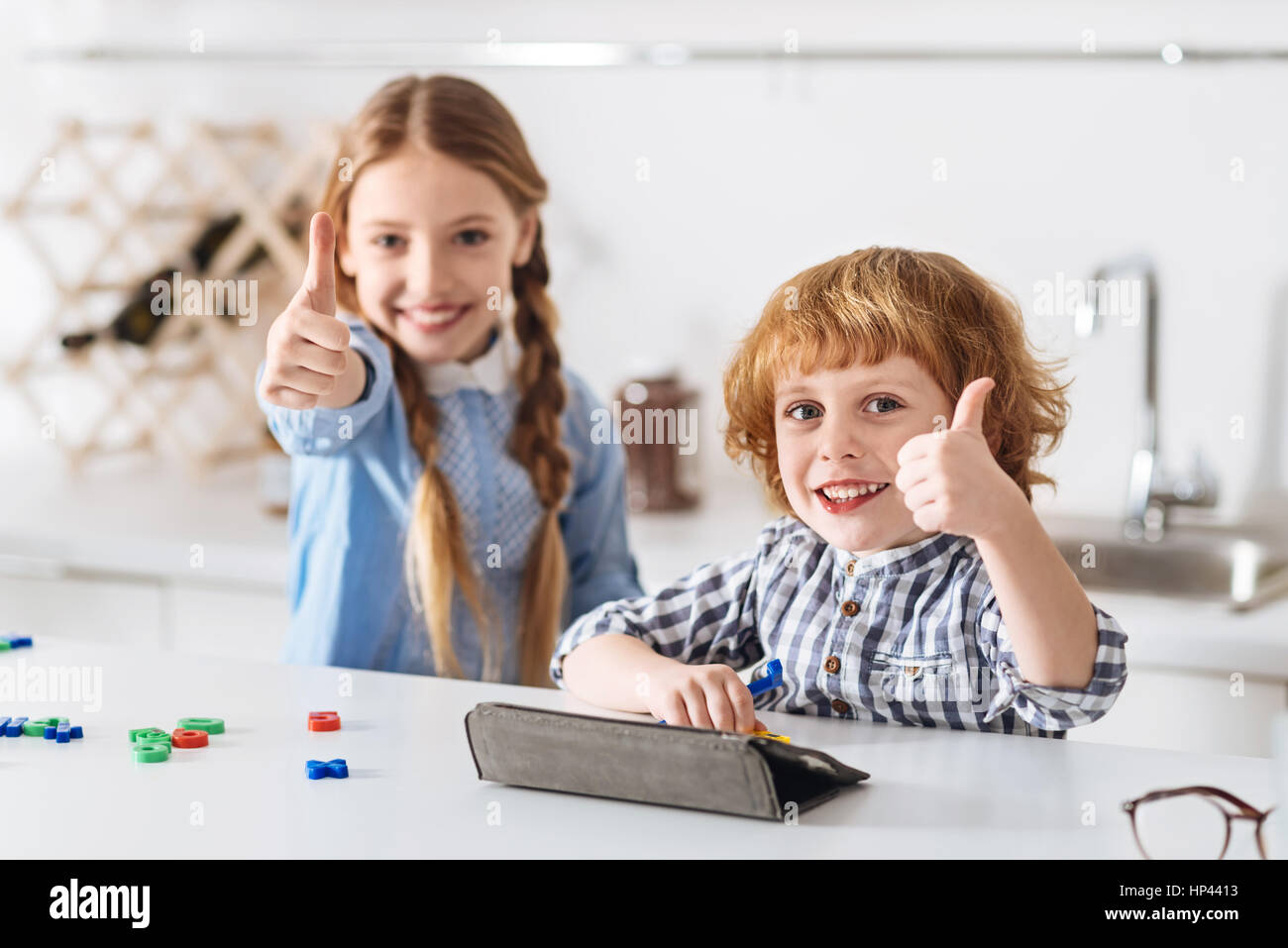 Brilliant happy kids liking their new learning games Stock Photo - Alamy