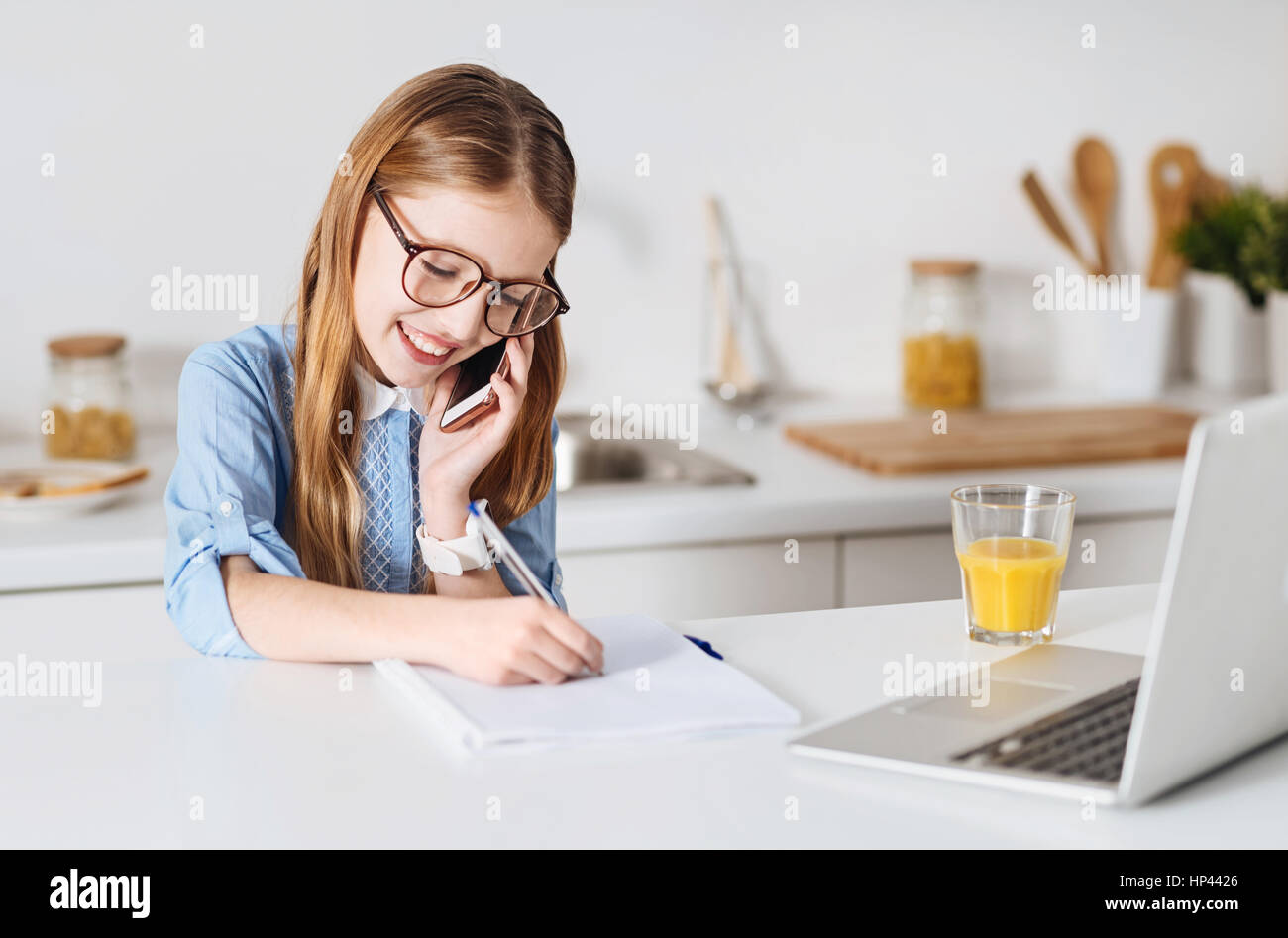 Active young lady calling her friend while studying Stock Photo - Alamy