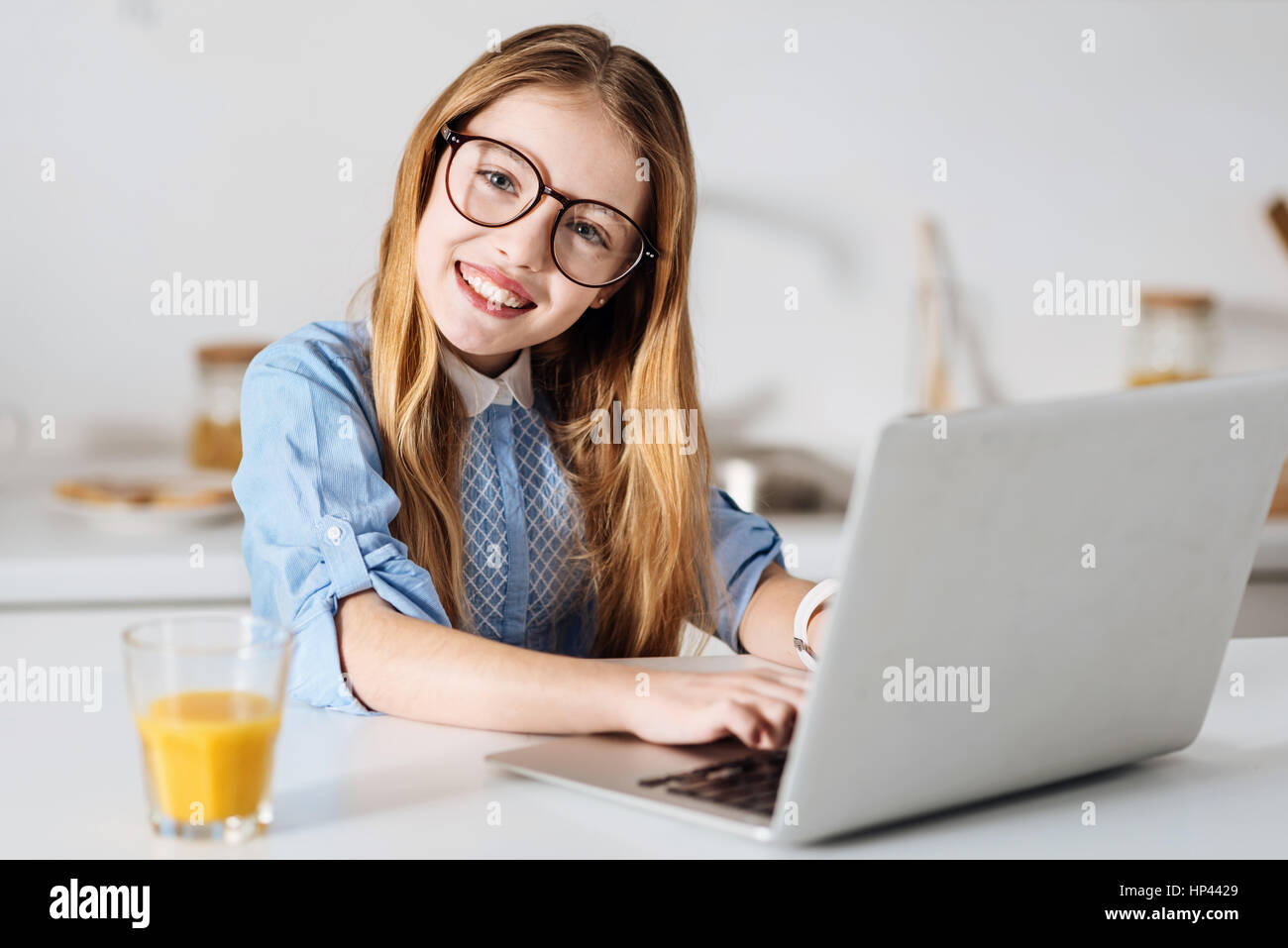 Enthusiastic bright girl typing on her laptop Stock Photo - Alamy