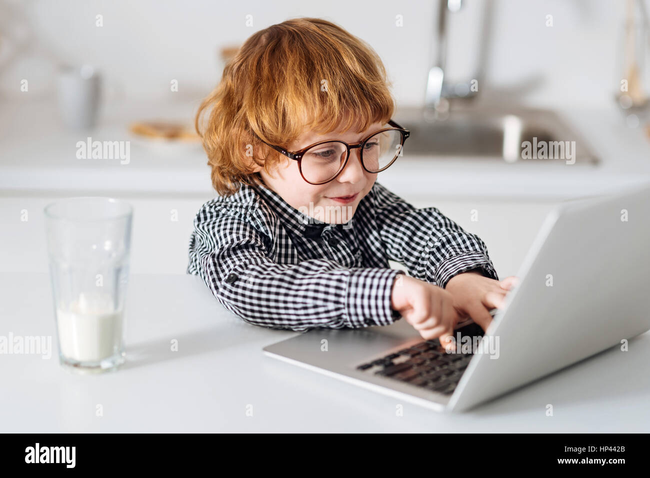 Creative cute kid writing something on his computer Stock Photo - Alamy