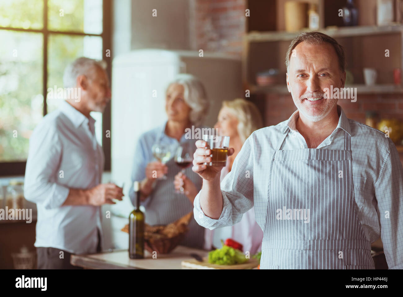 Positive aged man making a toast Stock Photo - Alamy