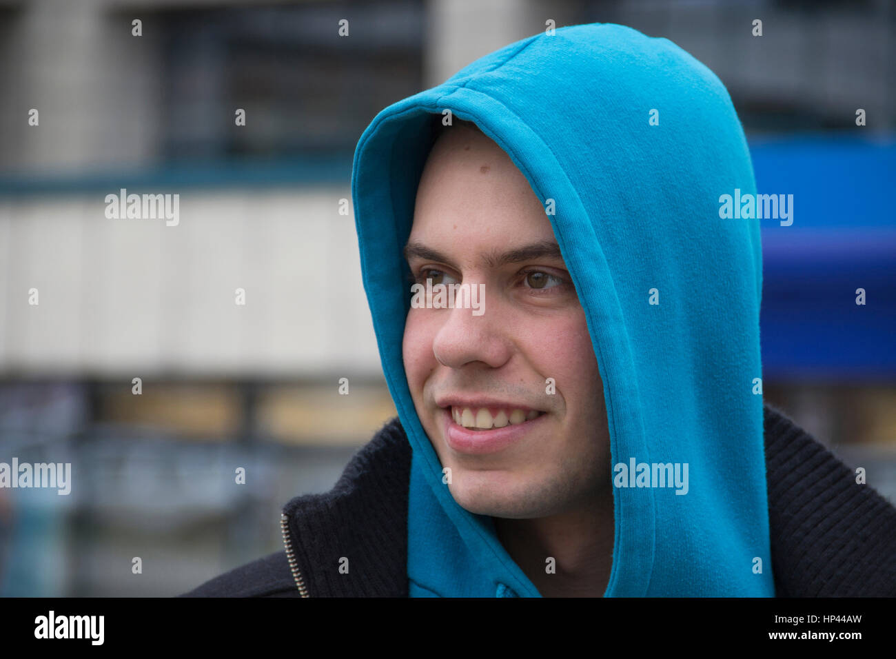 young man with a blue hood Stock Photo - Alamy