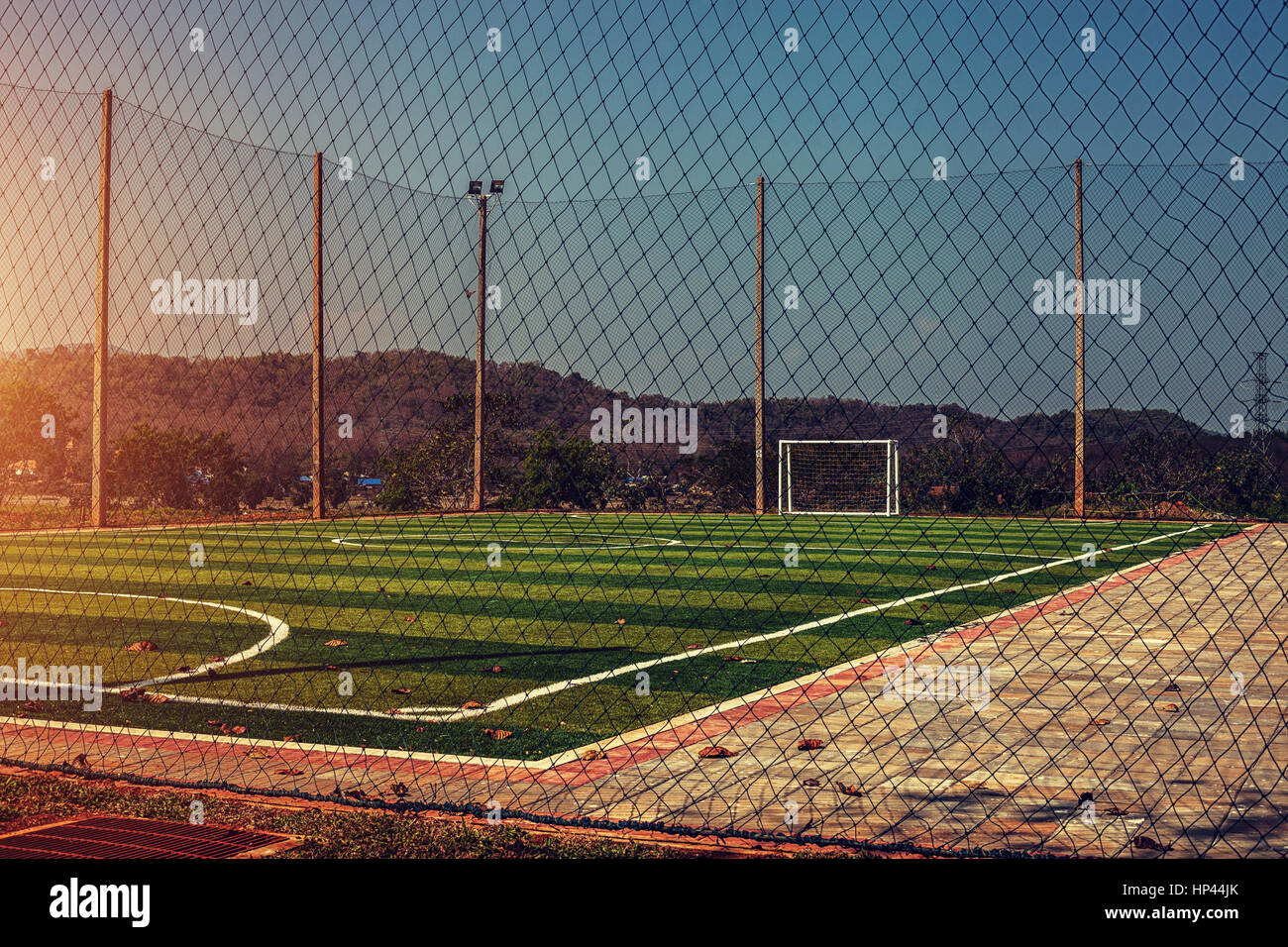 Artificial turf football field with vintage color filter and sunlight ...
