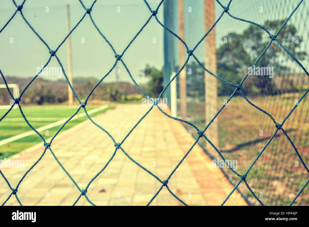 Artificial turf football field with vintage color filter and sunlight ...