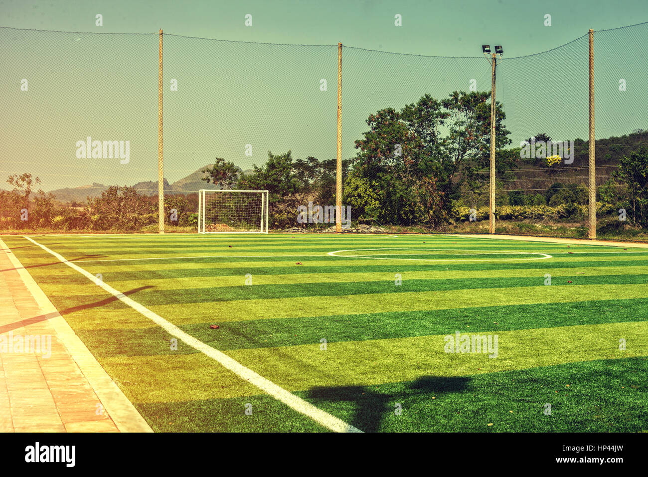 Artificial turf football field with vintage color filter and sunlight ...