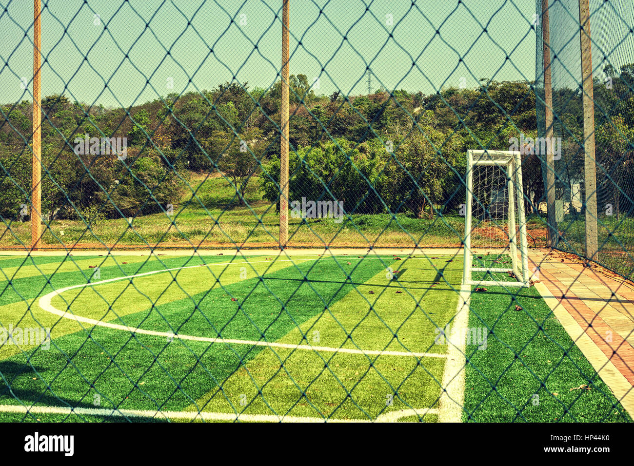 Artificial turf football field with vintage color filter and sunlight ...