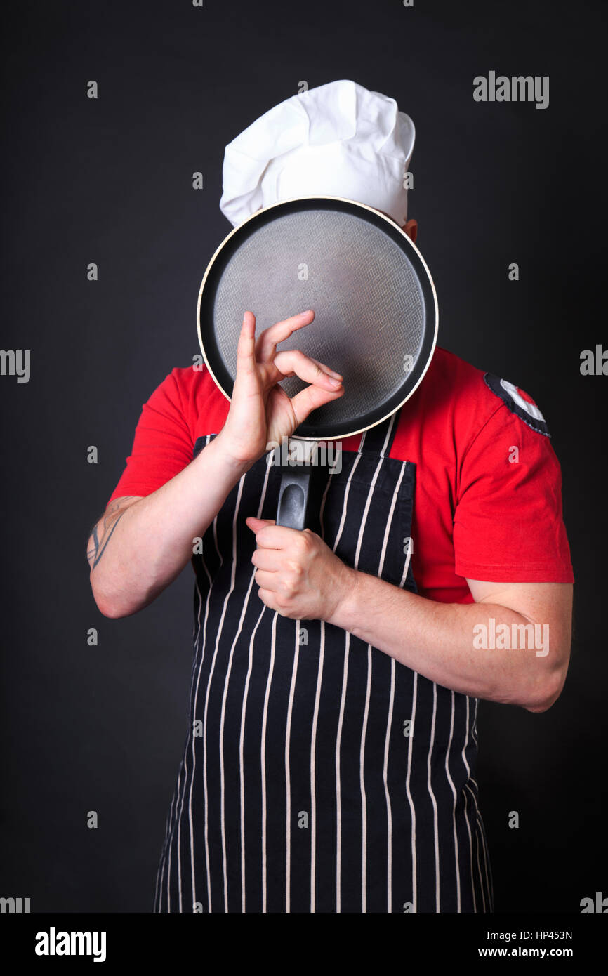 Studio shot of man with a frying pan, over dark background Stock Photo ...