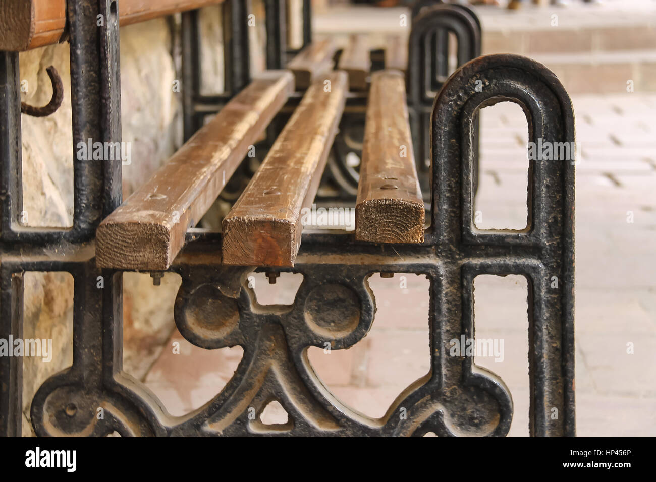Old style bench with metal frame and wooden seat Stock Photo - Alamy