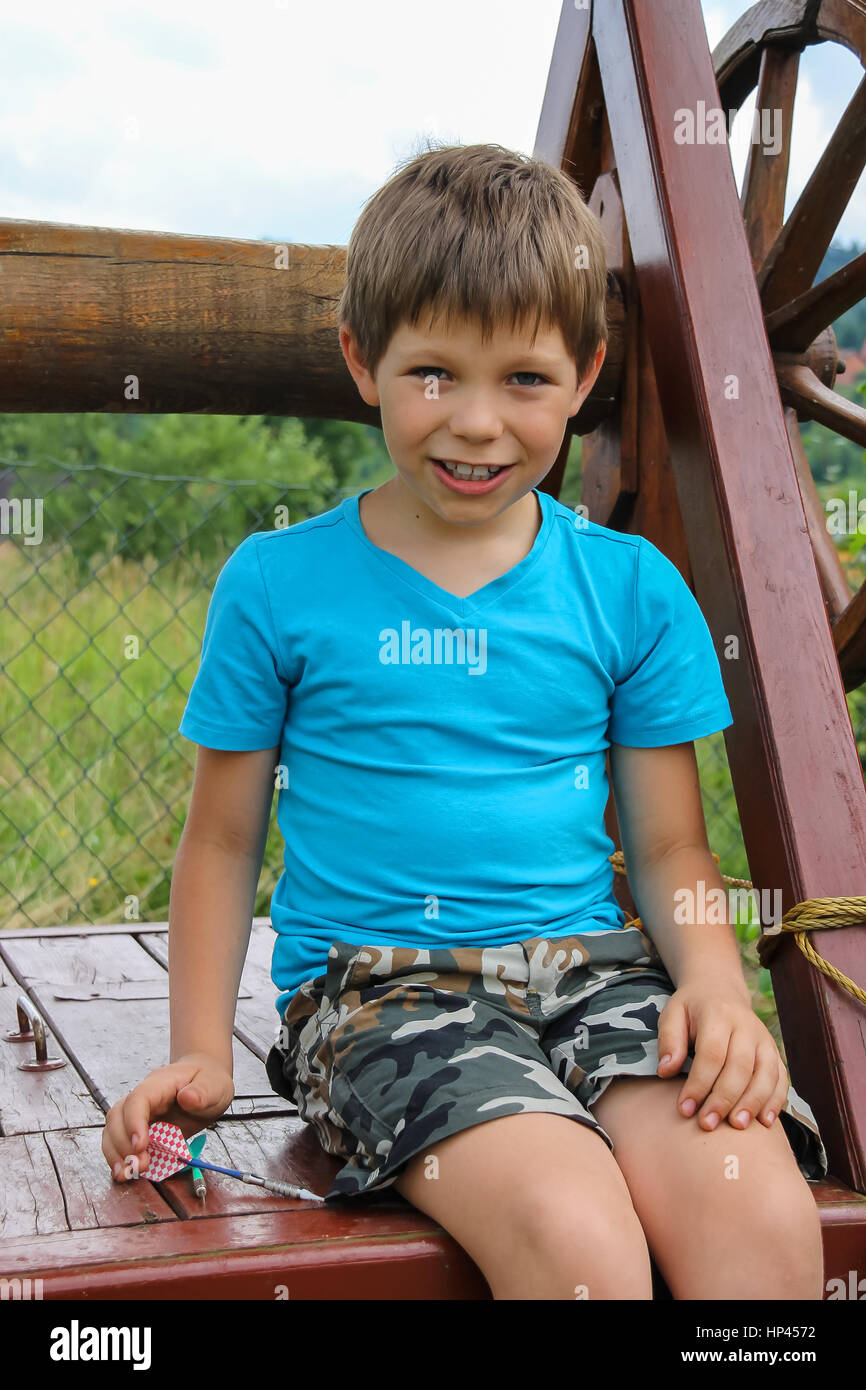 Smiling boy in front of old style wooden well Stock Photo - Alamy