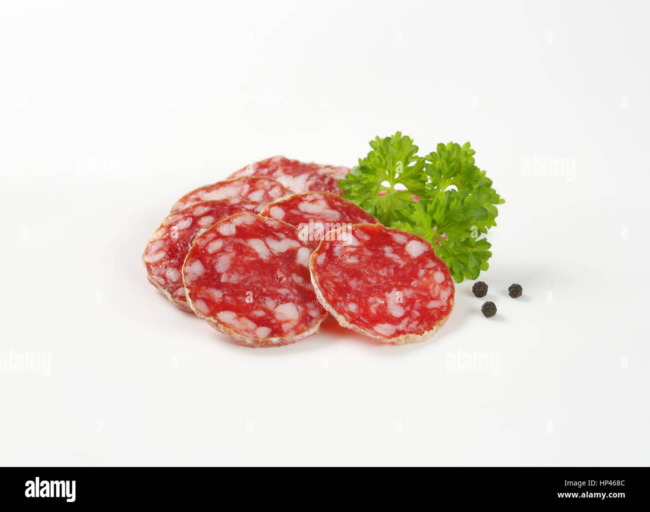 thin slices of french dry salami, parsley and peppercorns on white ...
