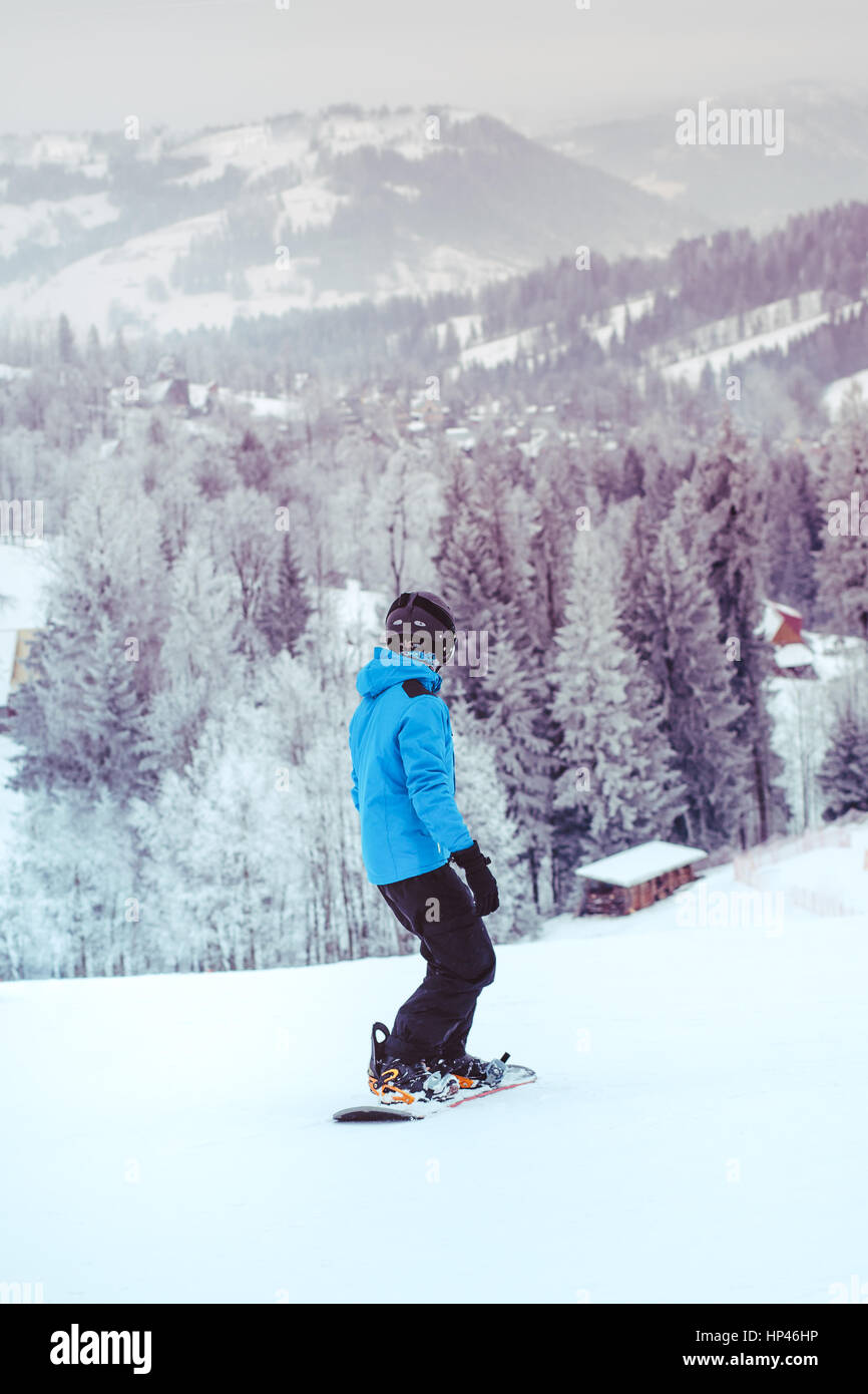 Boy riding a snowboard down the slope Stock Photo - Alamy