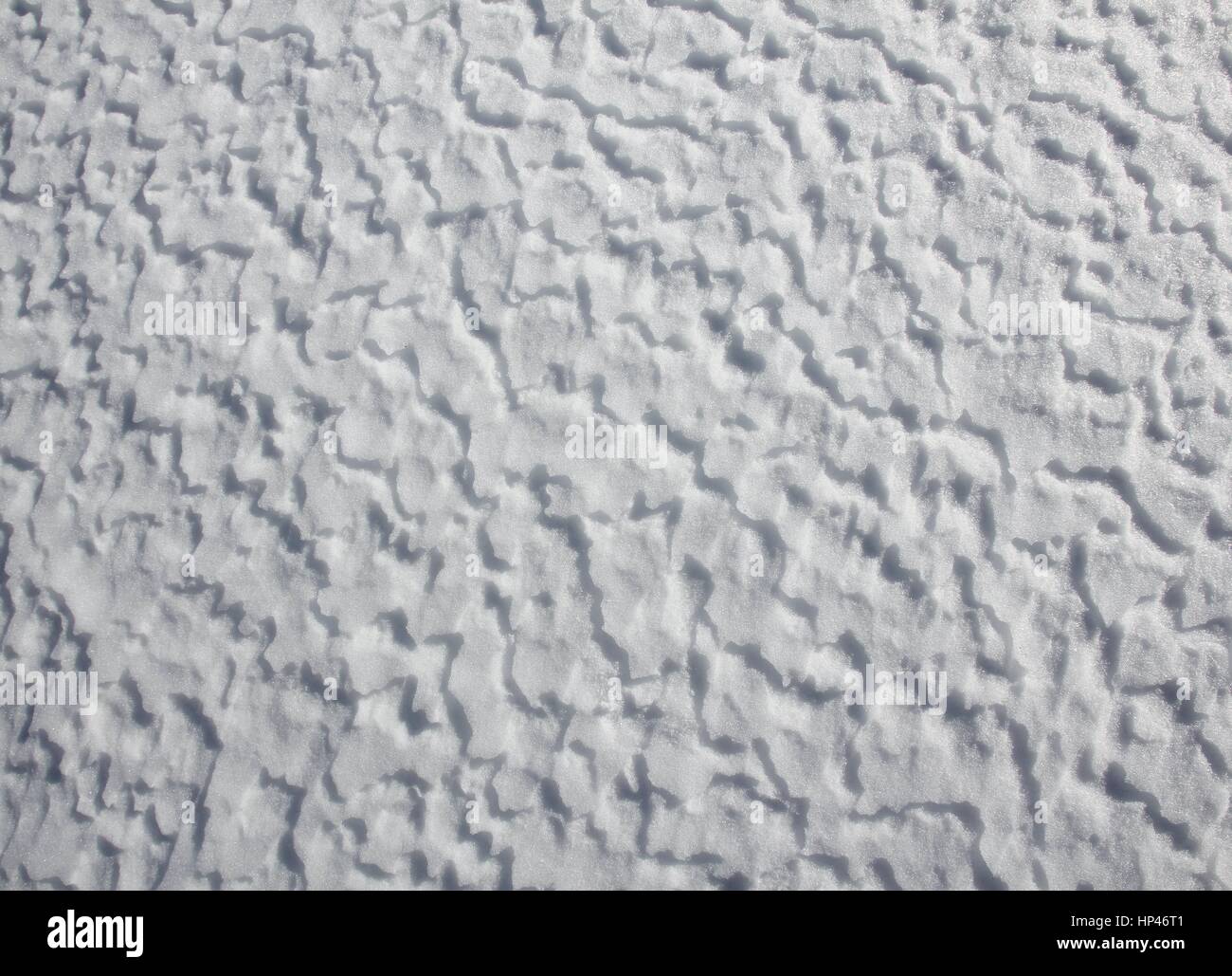Snow shaped by wind and weather Stock Photo - Alamy