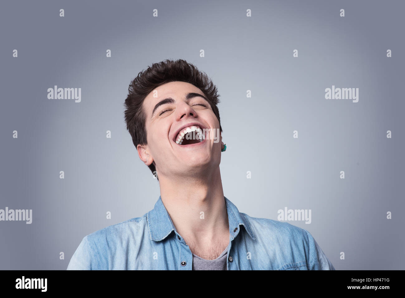 Funny smiling guy laughing out loud with closed eyes Stock Photo - Alamy