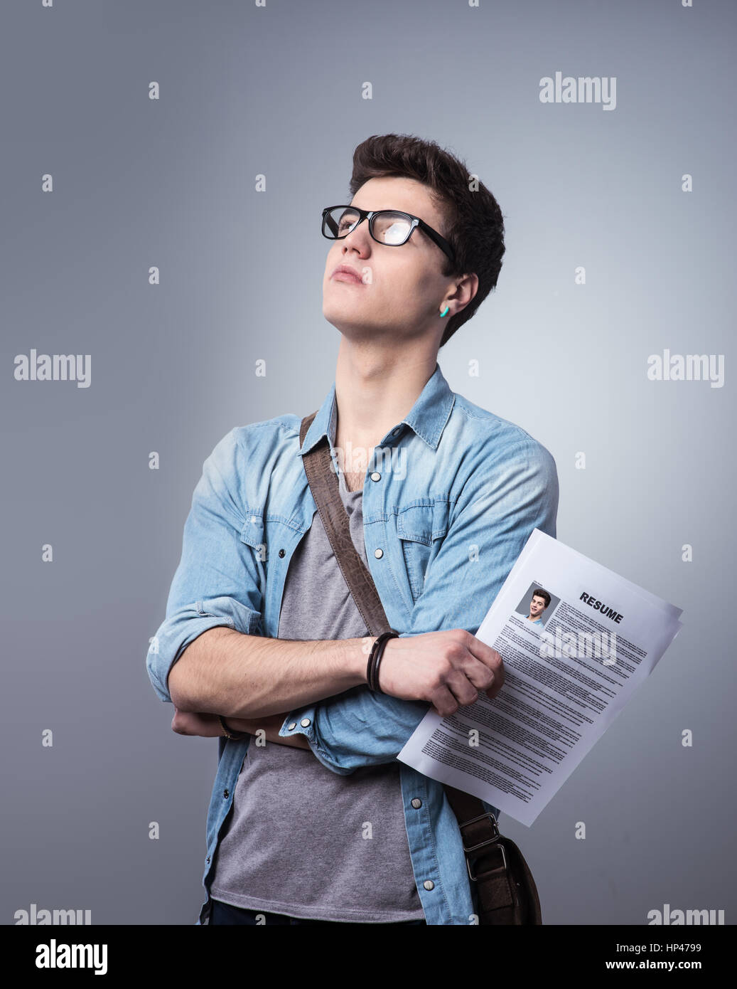 Young pensive man holding his resume applying for a job Stock Photo - Alamy