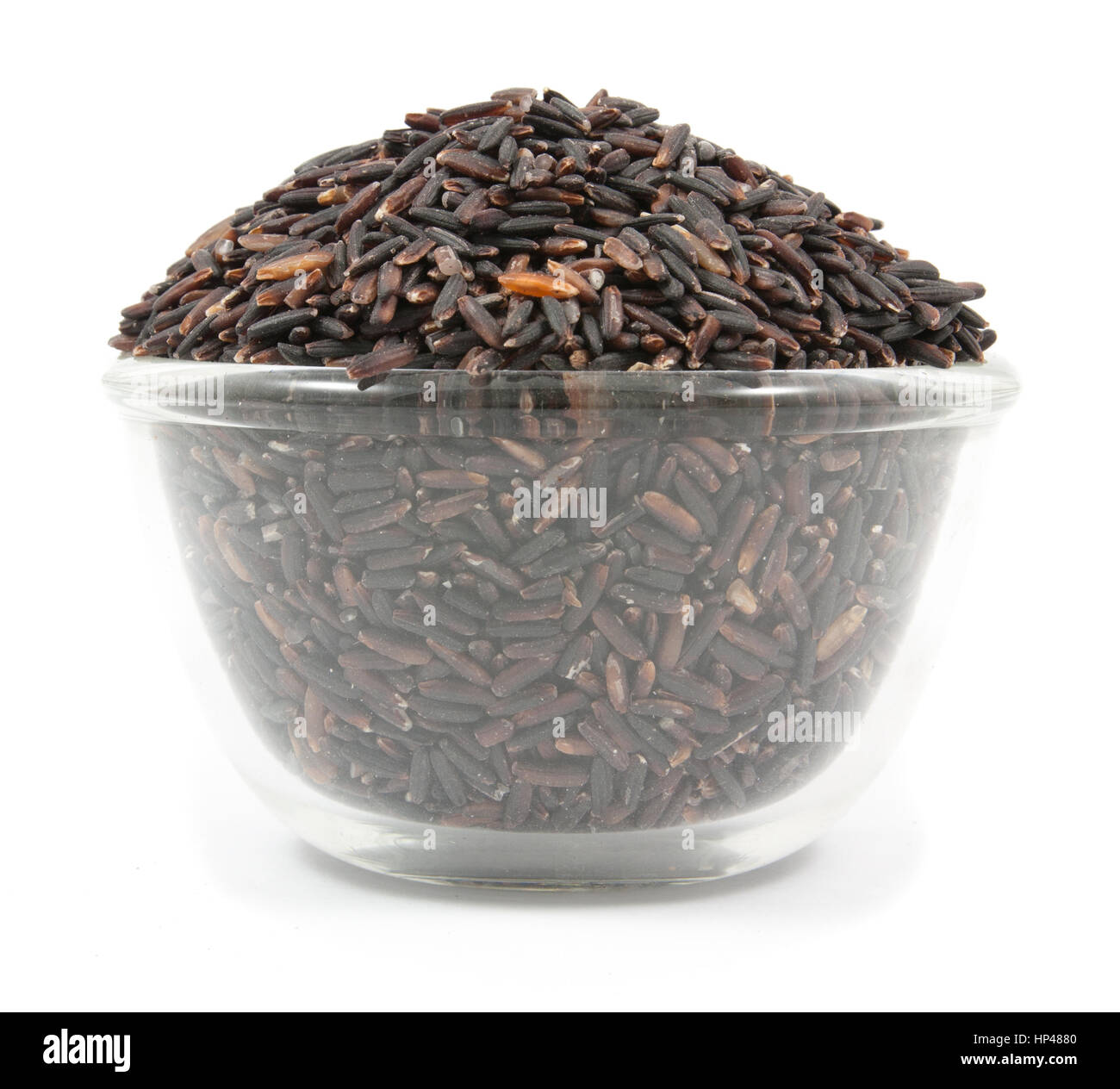 Black rice on glass cup isolated on a white background Stock Photo - Alamy