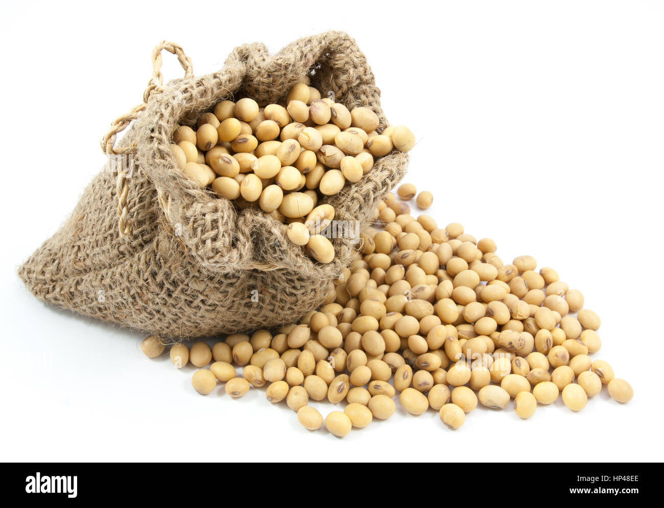 Dried soybean in canvas sack on white background Stock Photo - Alamy