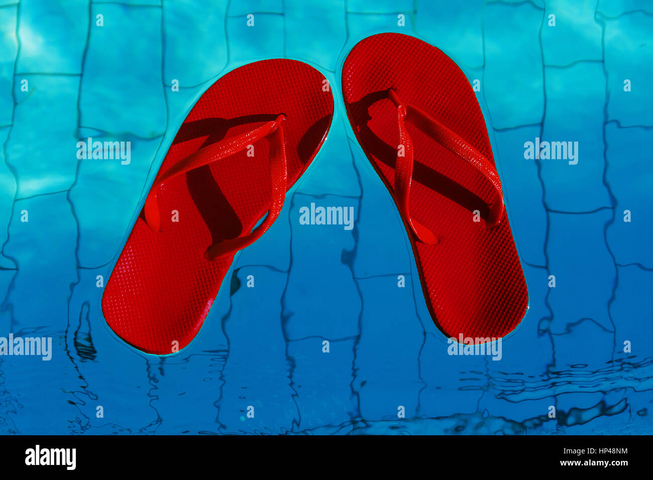red flip-flops floating in a swimming pool, a top view Stock Photo - Alamy