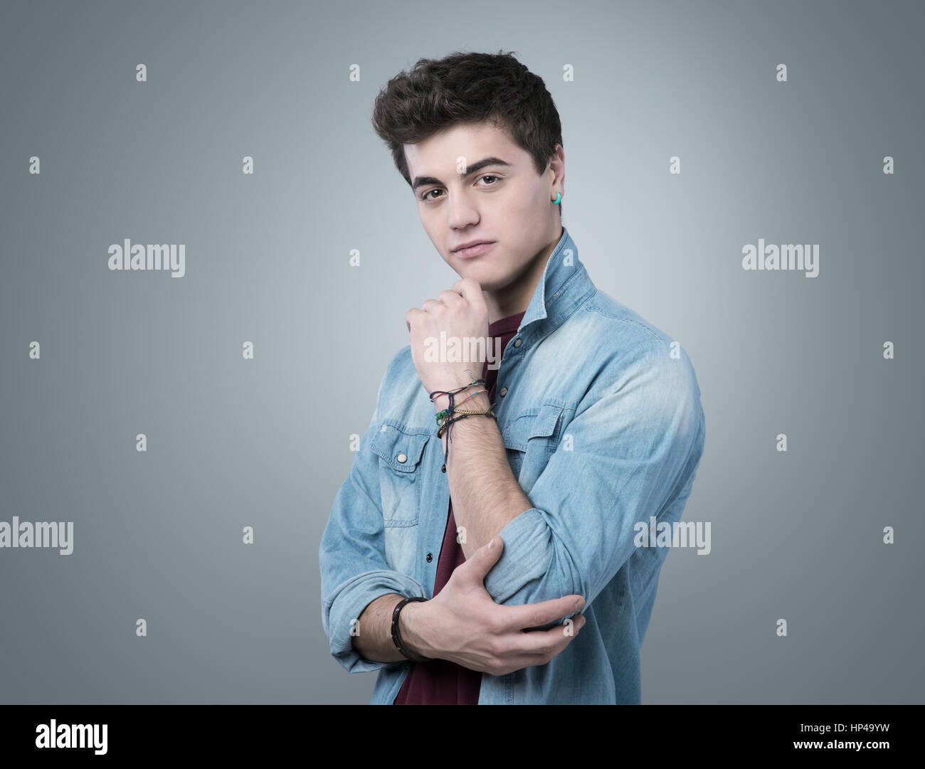 Attractive smirking boy flirting with hand on chin Stock Photo - Alamy