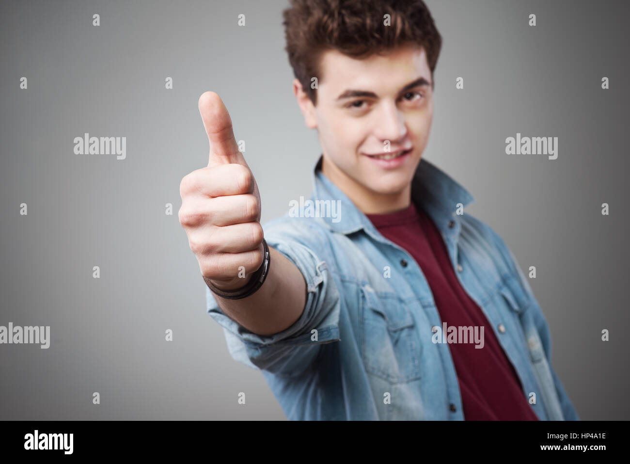 Smiling confident teenager thumbs up looking at camera Stock Photo - Alamy