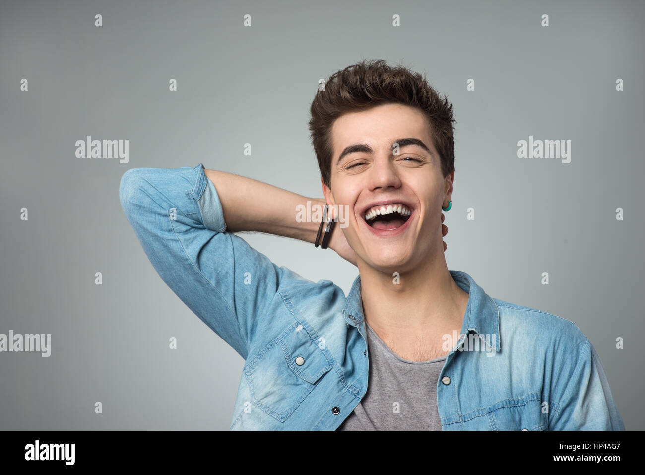 Funny smiling guy laughing out loud with closed eyes Stock Photo - Alamy