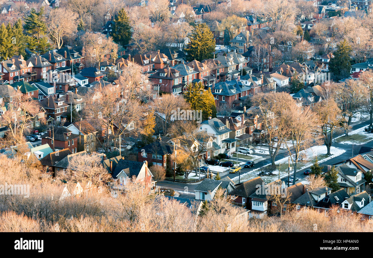 Neighborhood community seen from above at sunrise, houses nestled among ...