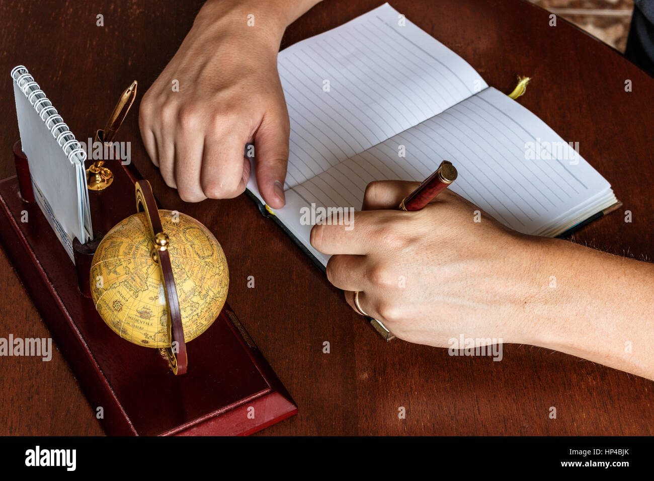 man writes with his left hand in the diary entries. left-handed Stock ...