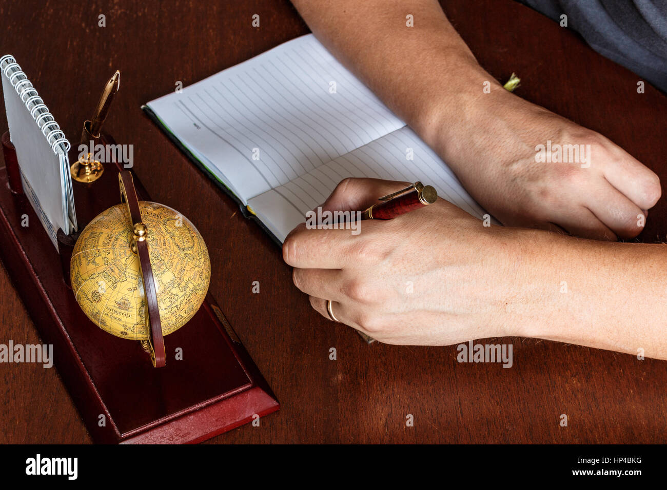 man writes with his left hand in the diary entries. left-handed Stock ...