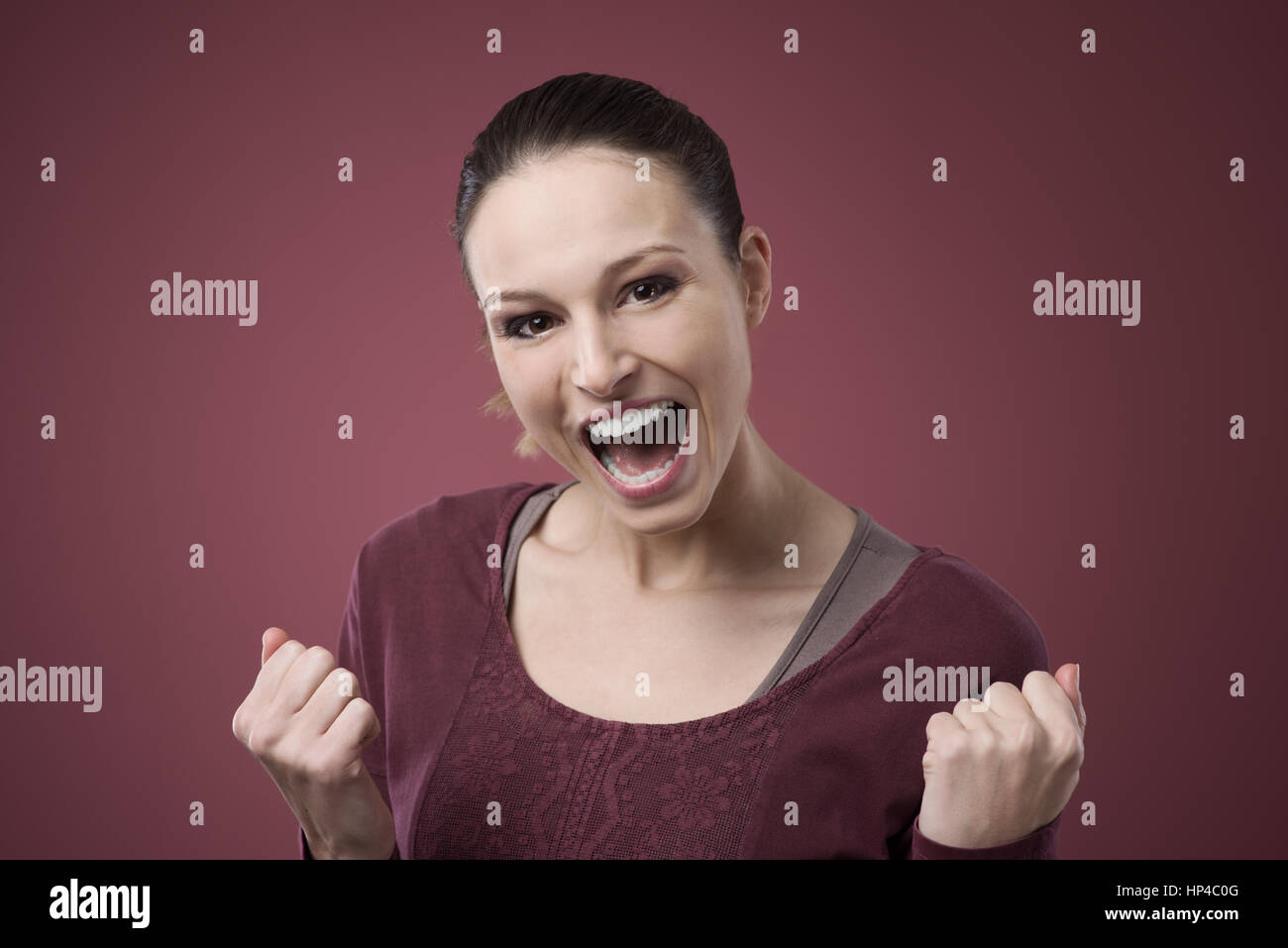 Cheerful winning woman shouting and looking at camera Stock Photo - Alamy