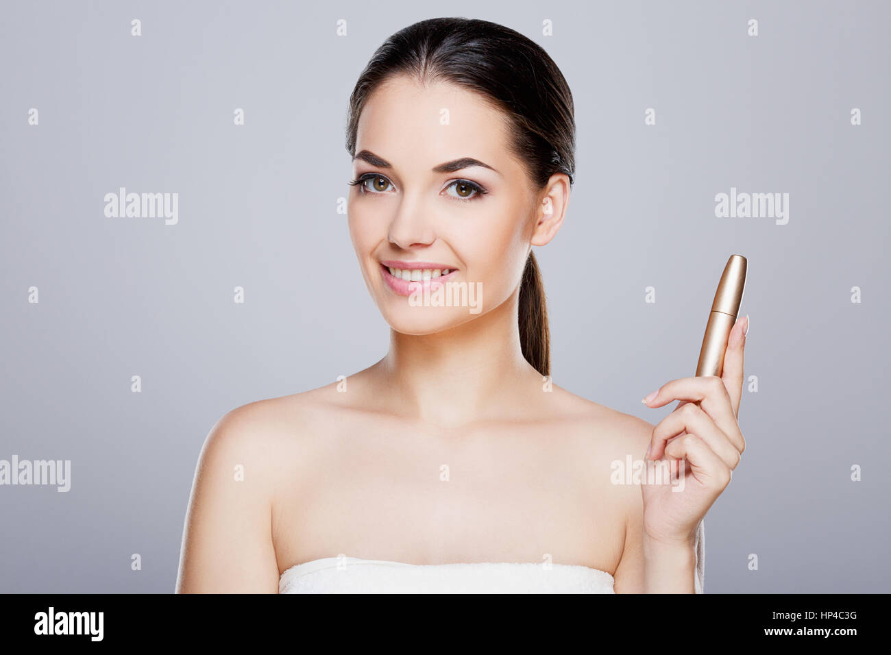 Girl holding mascara Stock Photo - Alamy
