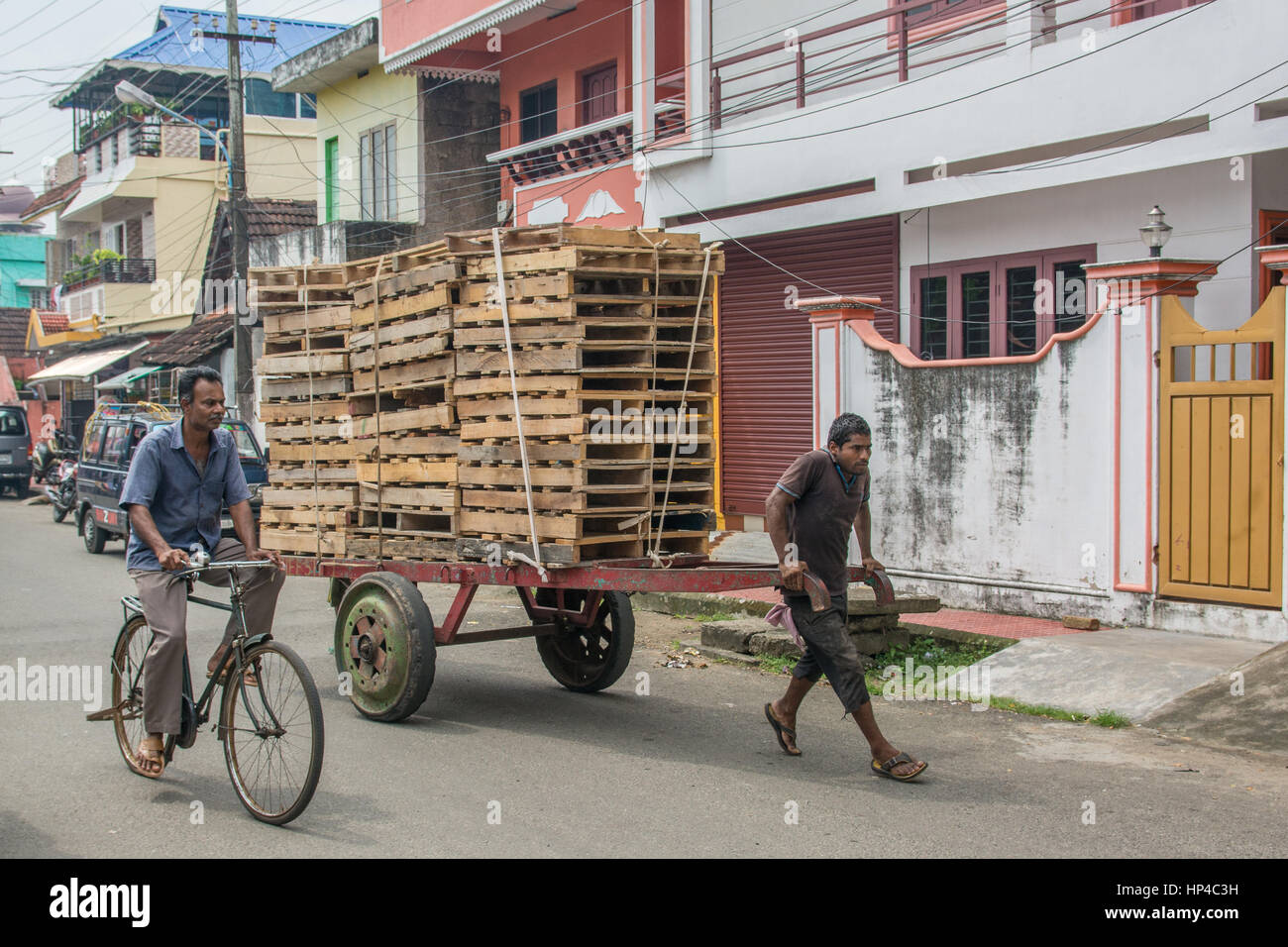 Mumbai, India - December 11, 2016 - Man pulling a cart with pallets ...