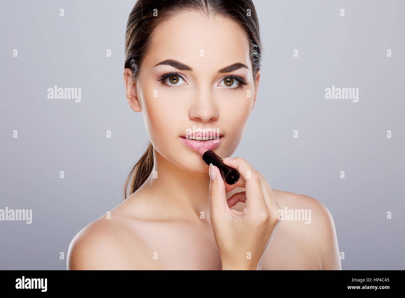Model painting lips with lipstick Stock Photo - Alamy