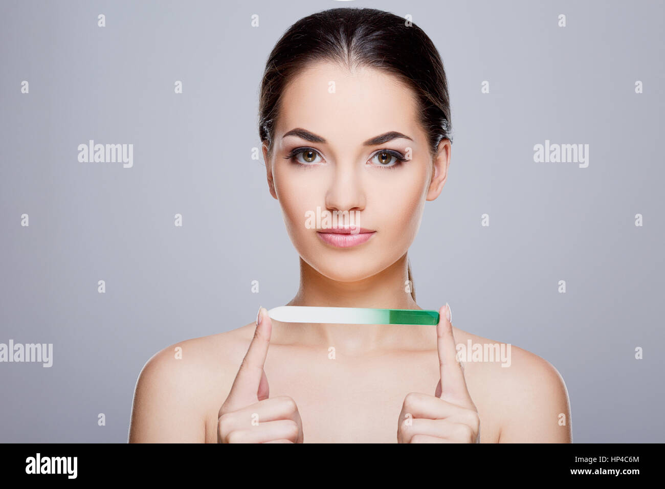 Girl holding nail file Stock Photo - Alamy