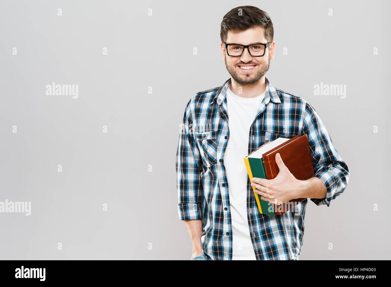 Man holding books with one hand Stock Photo - Alamy