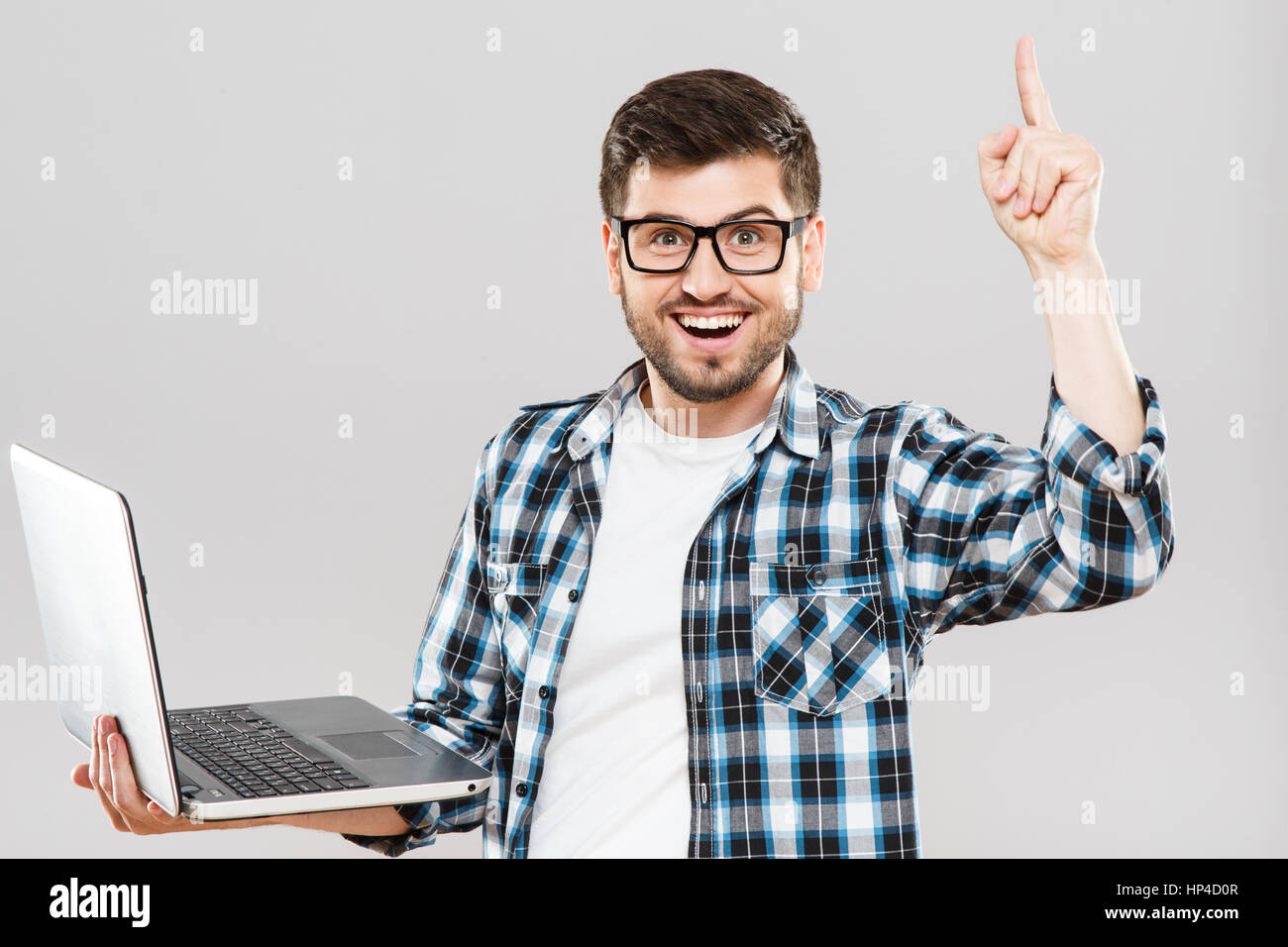 Smiling man in glasses with laptop has idea Stock Photo - Alamy
