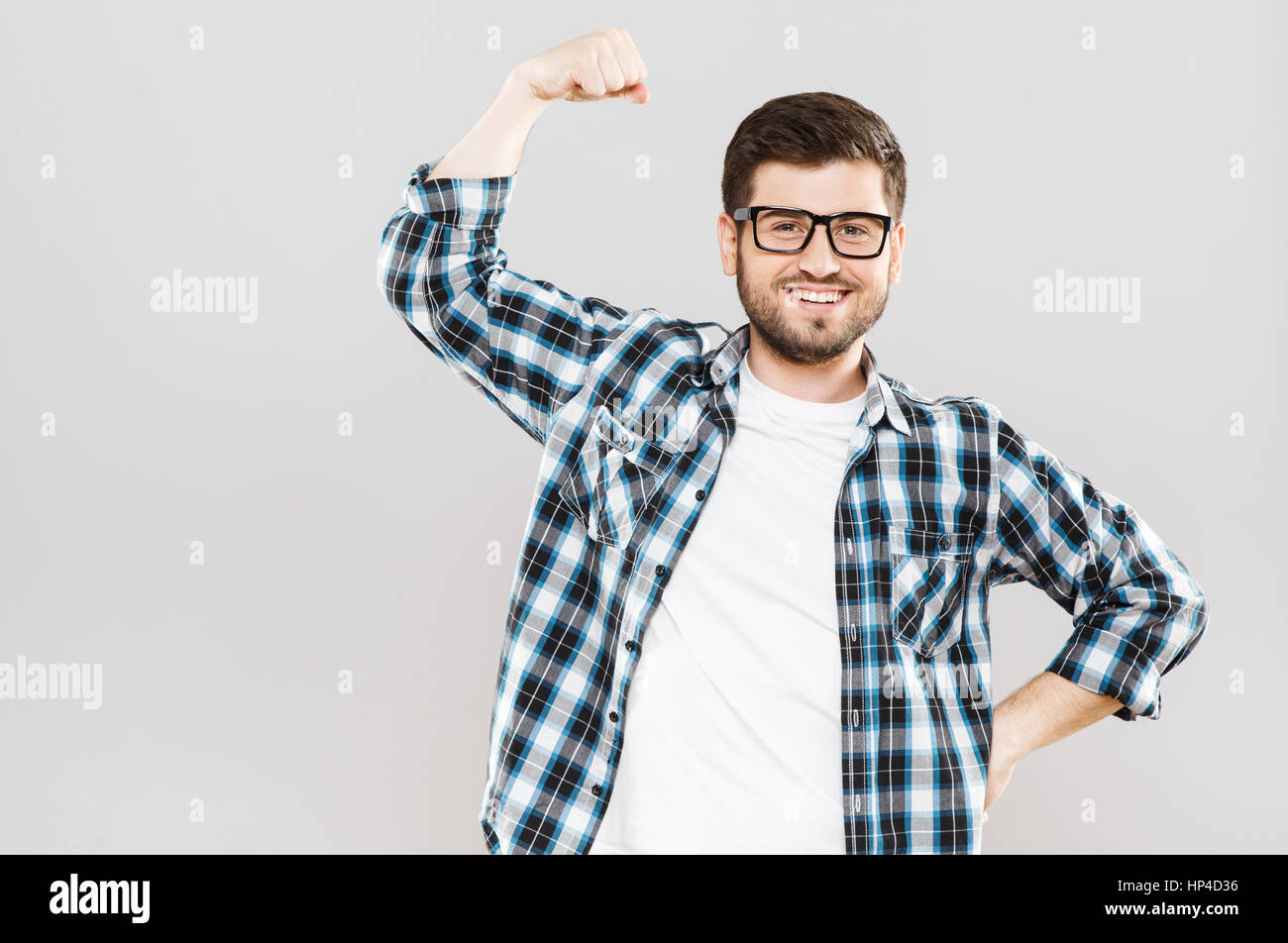 Young man showing strength Stock Photo - Alamy