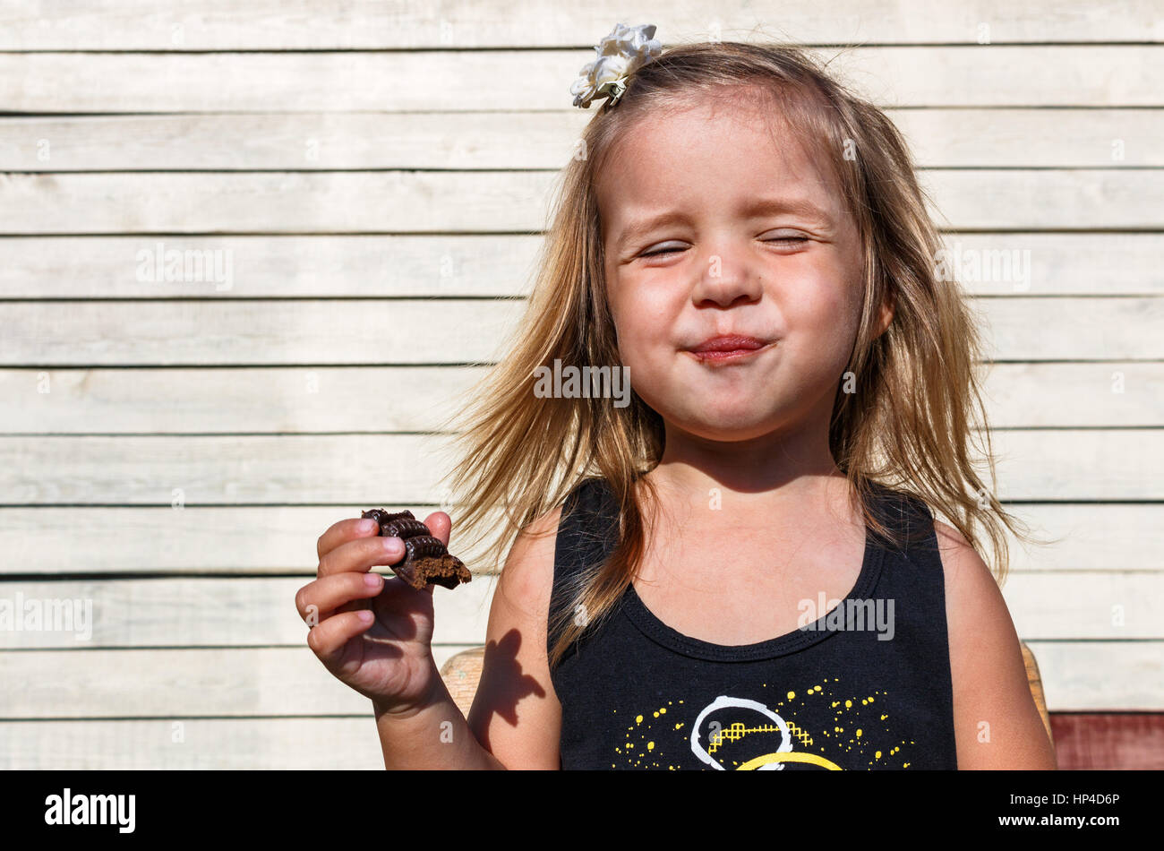 little girl eats tasty chocolate Stock Photo - Alamy