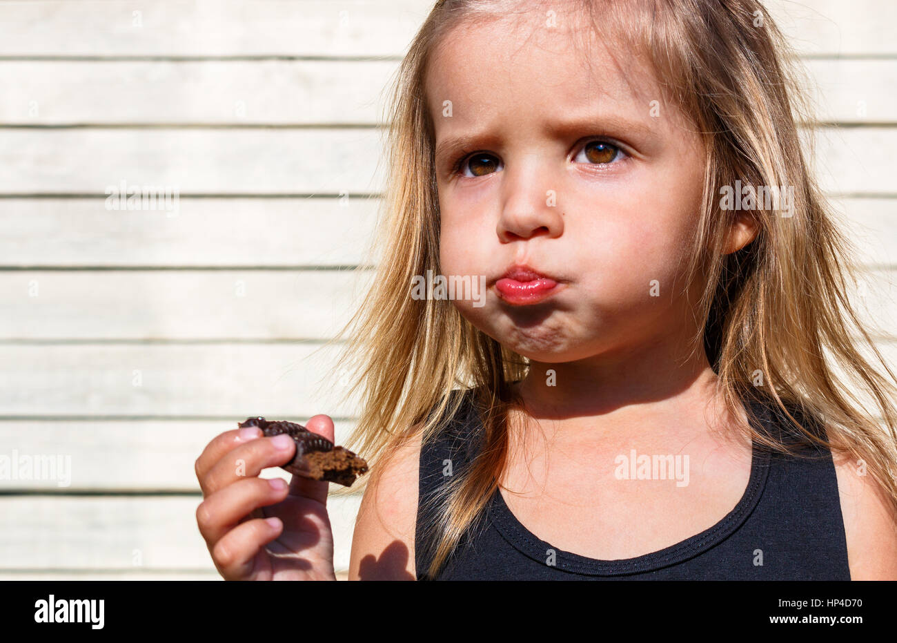 little girl eats tasty chocolate Stock Photo - Alamy