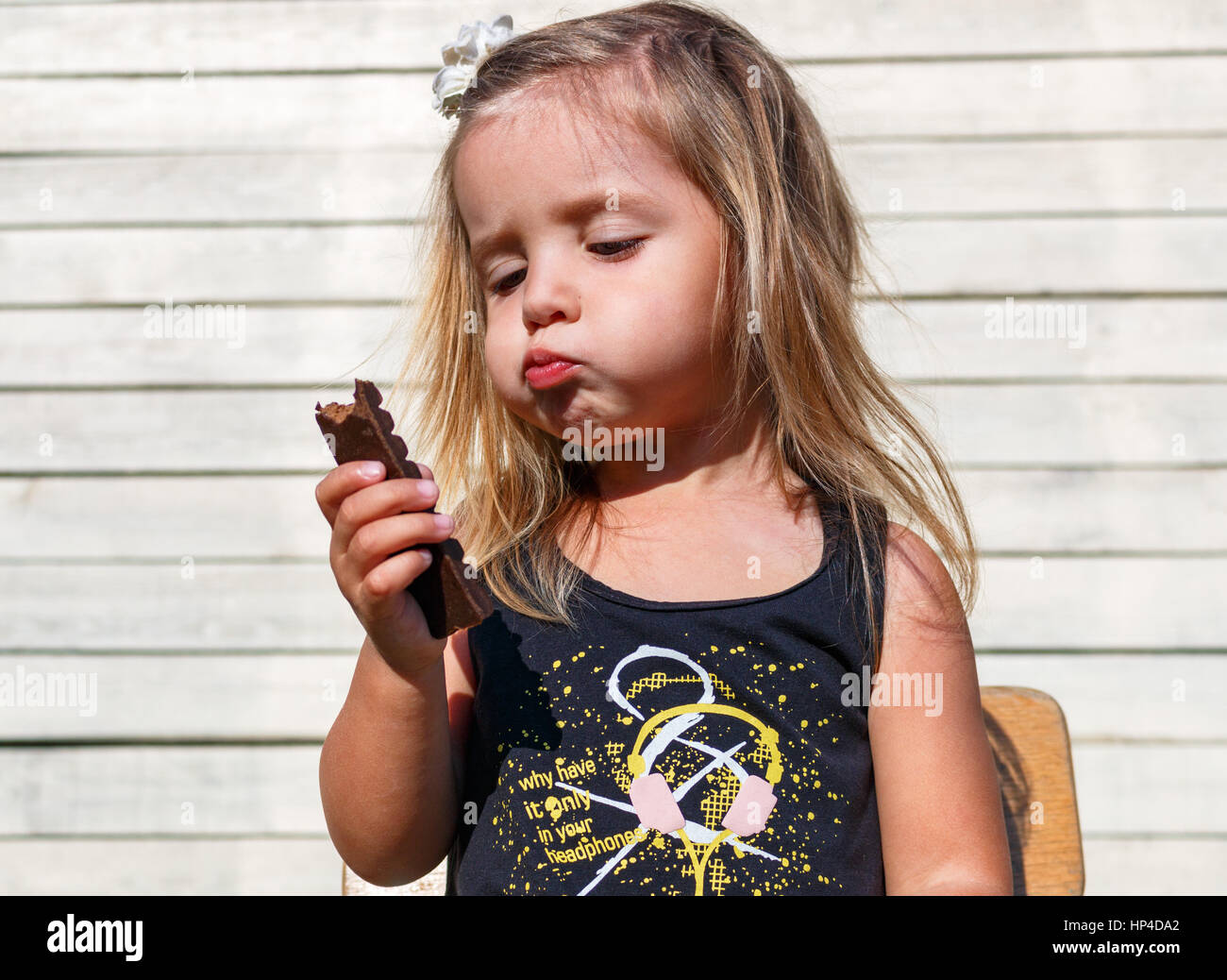 little girl eats tasty chocolate Stock Photo - Alamy