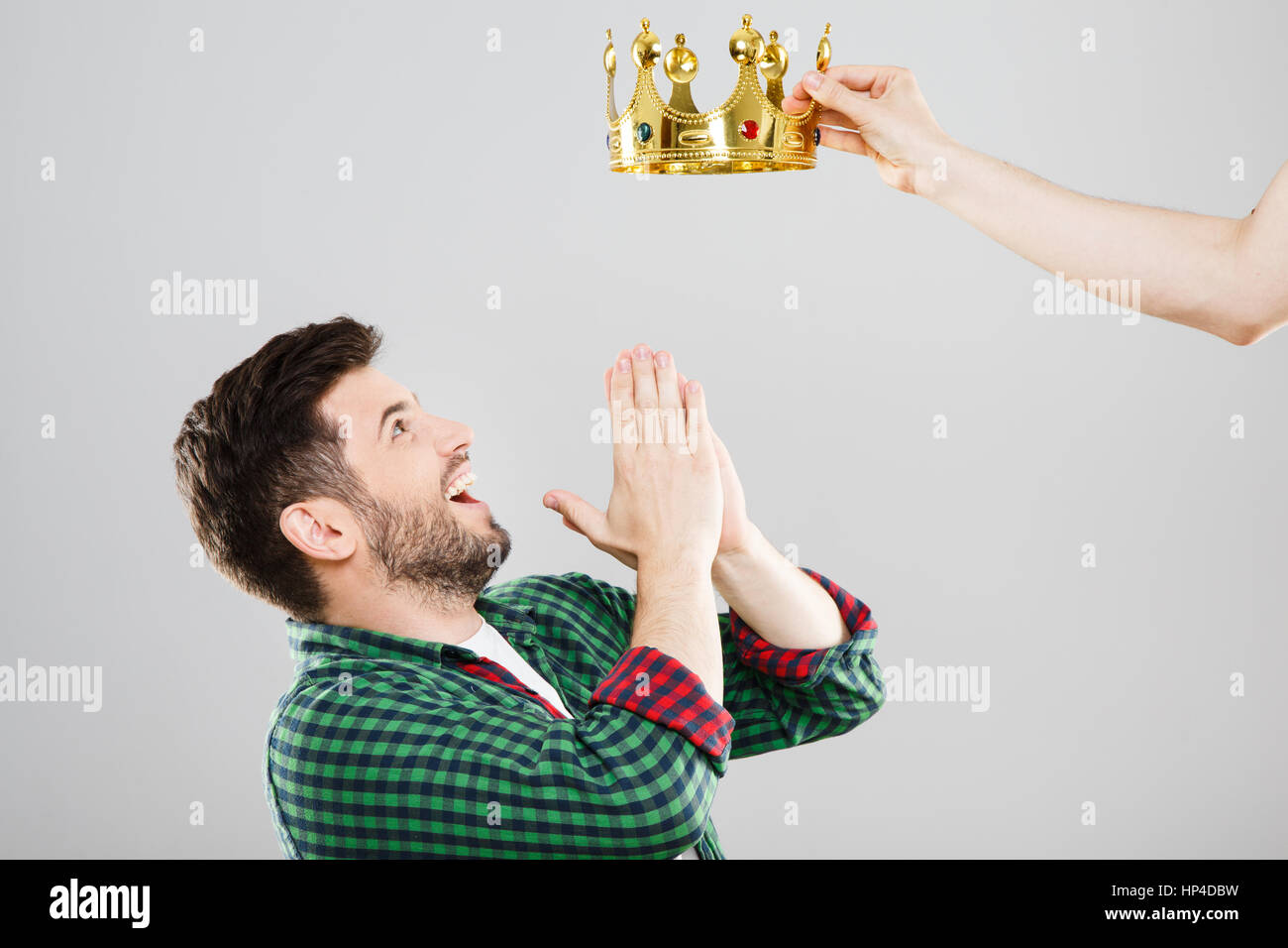 Surprised young man with crown above his head Stock Photo - Alamy