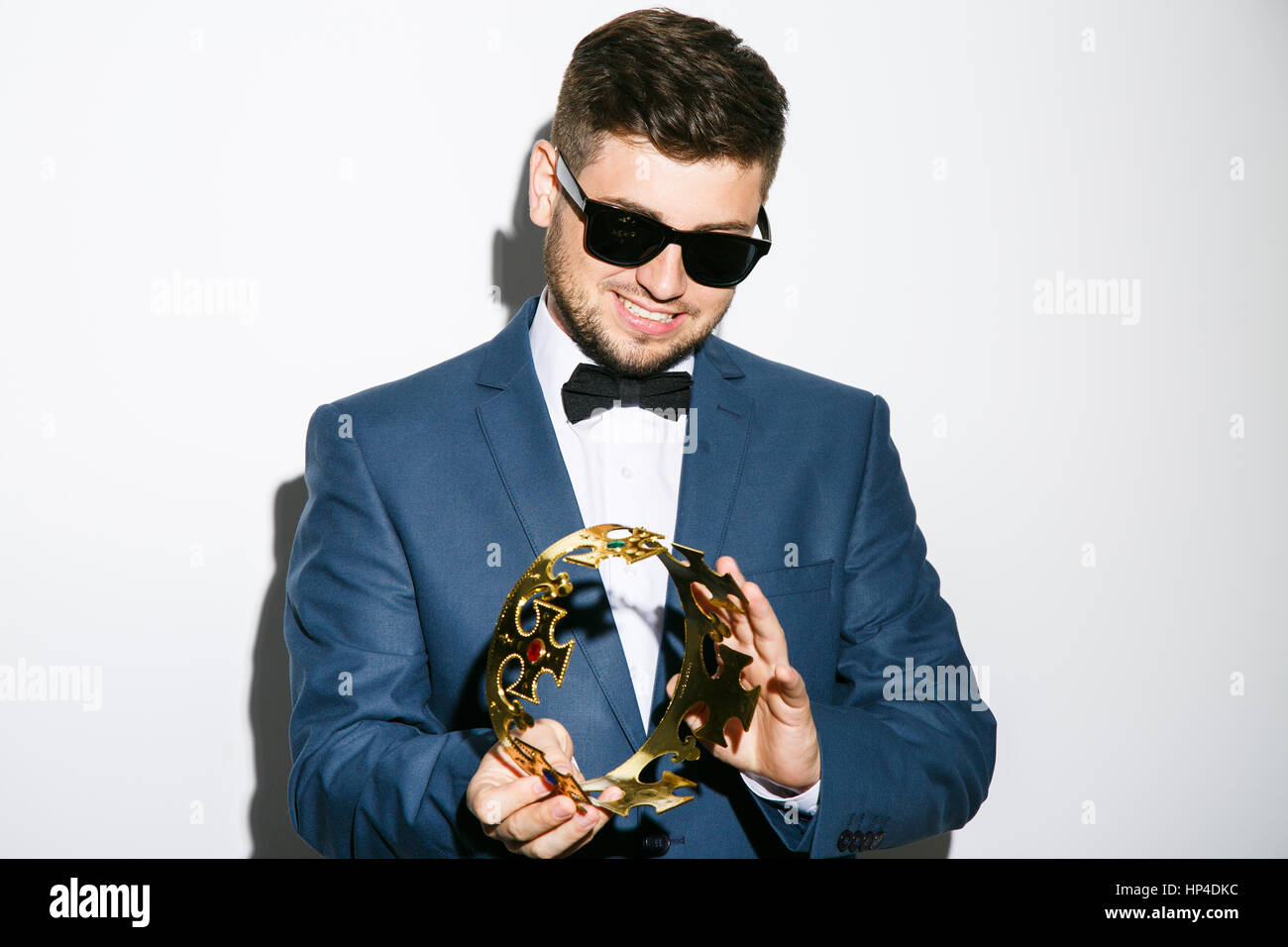 Man holding crown and smiling Stock Photo - Alamy