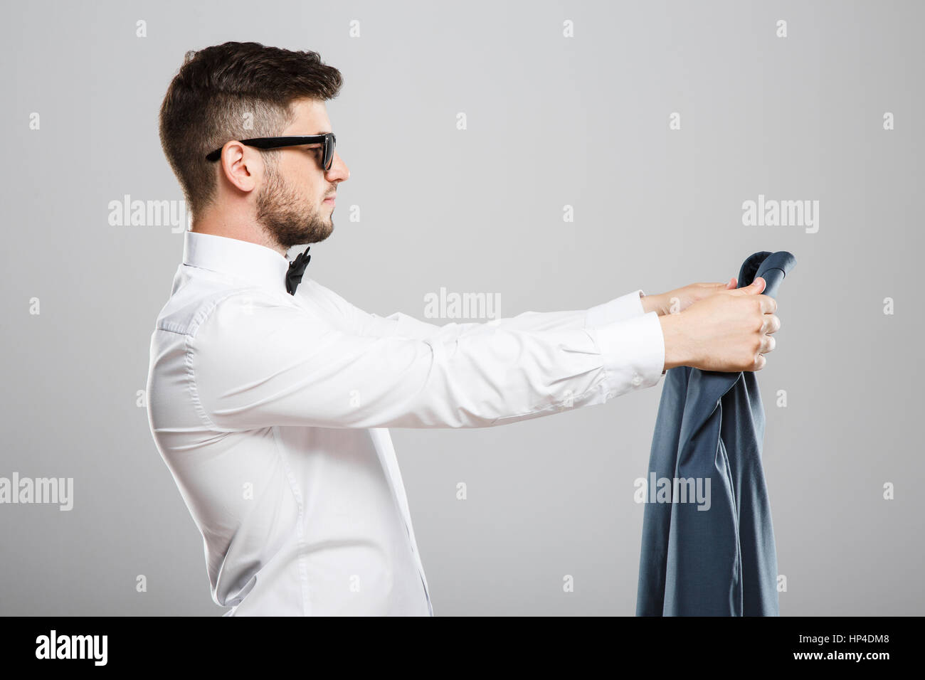 Young man holding jacket Stock Photo - Alamy