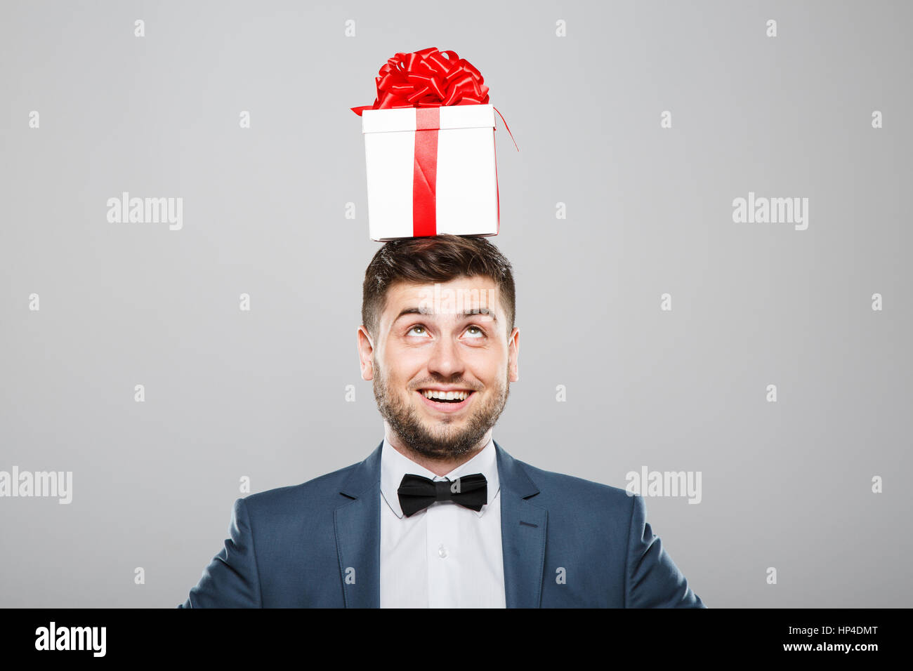 Man looking up at present on his head Stock Photo - Alamy