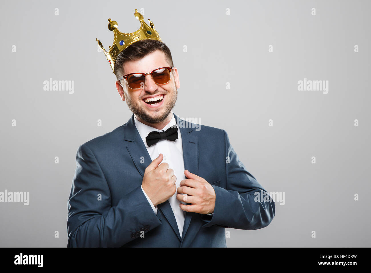 Man in crown laughing Stock Photo - Alamy