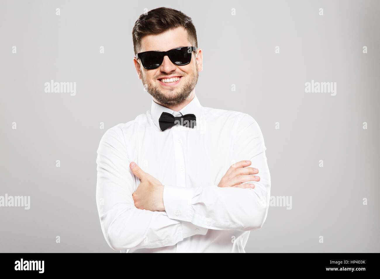 Smiling man at gray background Stock Photo - Alamy