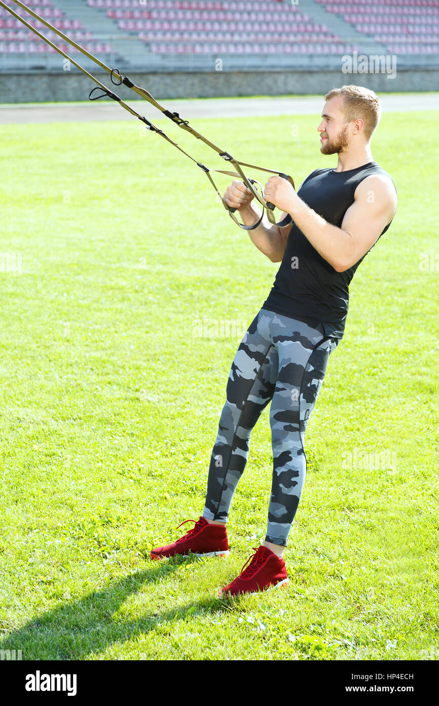 Man pulling training loop to himself Stock Photo - Alamy