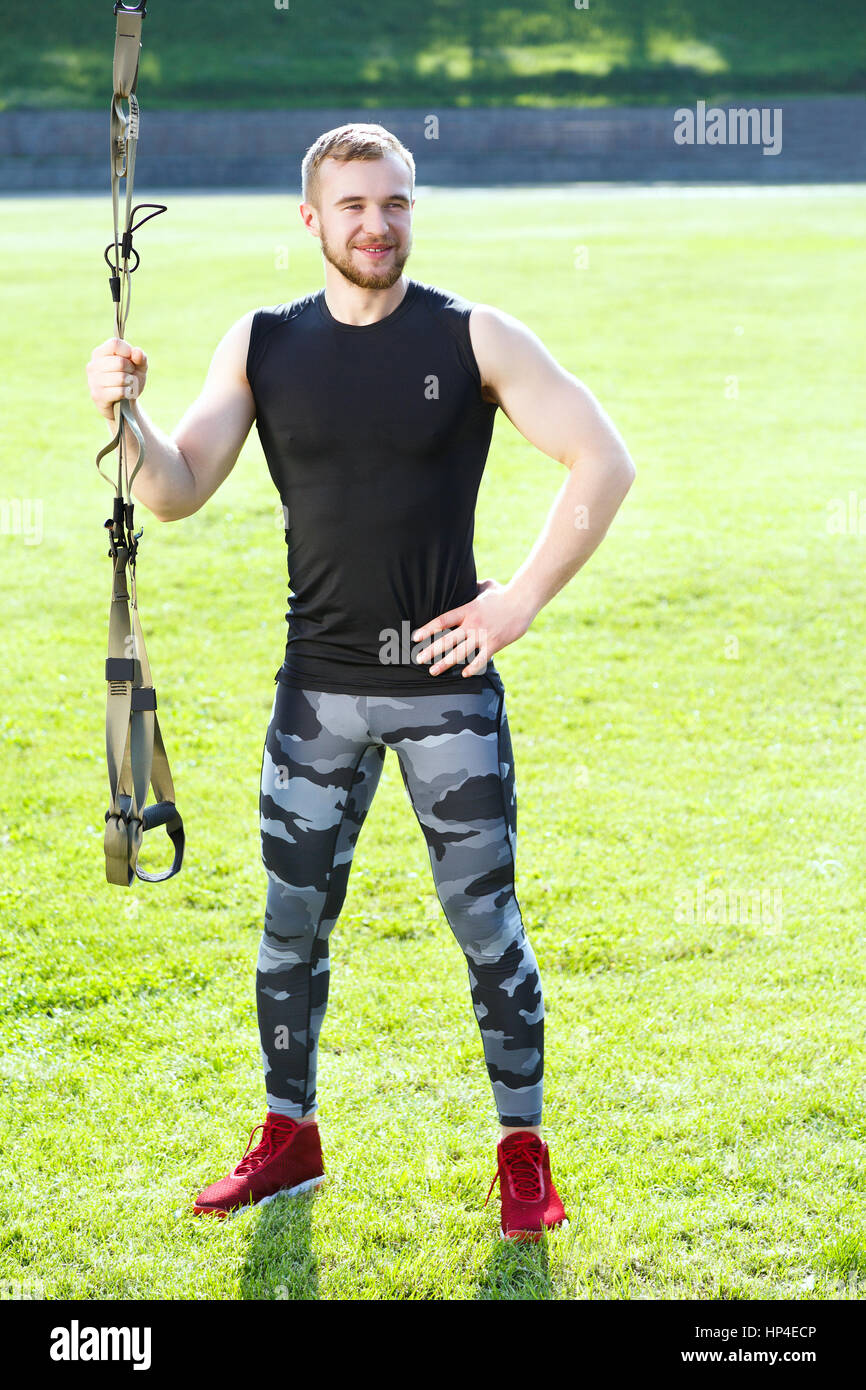 Man standing near training loop on stadium Stock Photo - Alamy