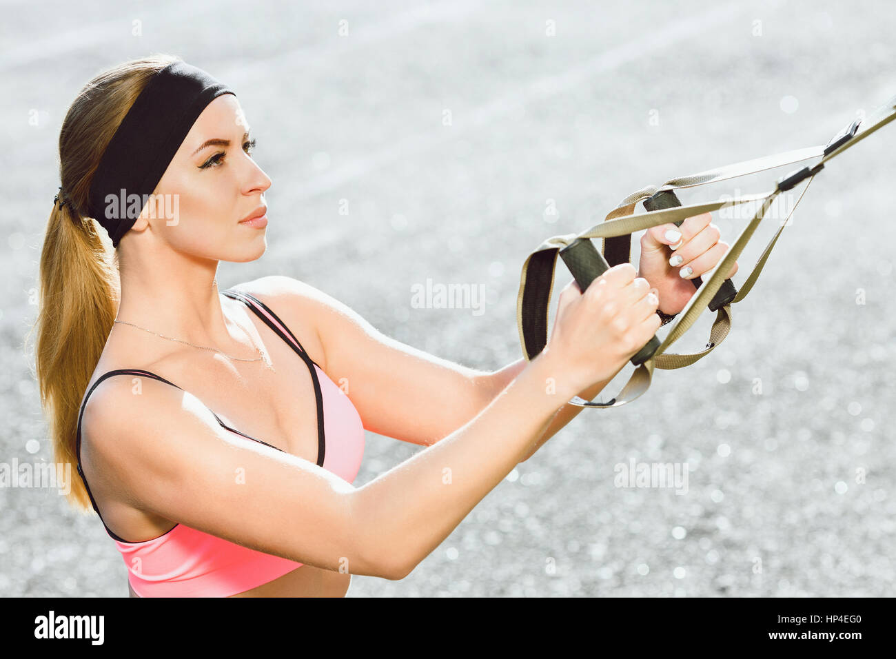 Profile of girl doing exercises with training loop Stock Photo - Alamy