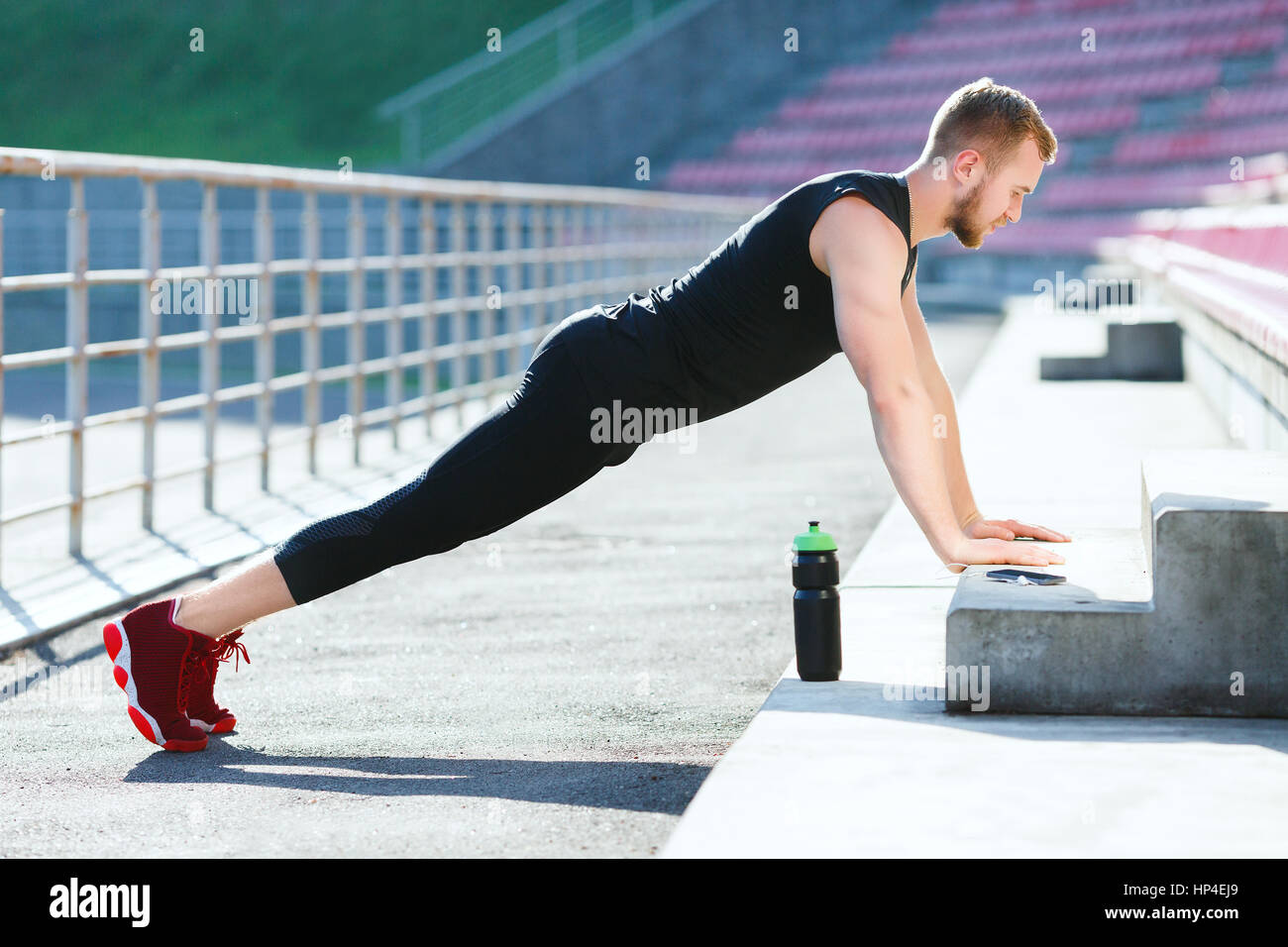 Sportsman standing in plank position Stock Photo - Alamy