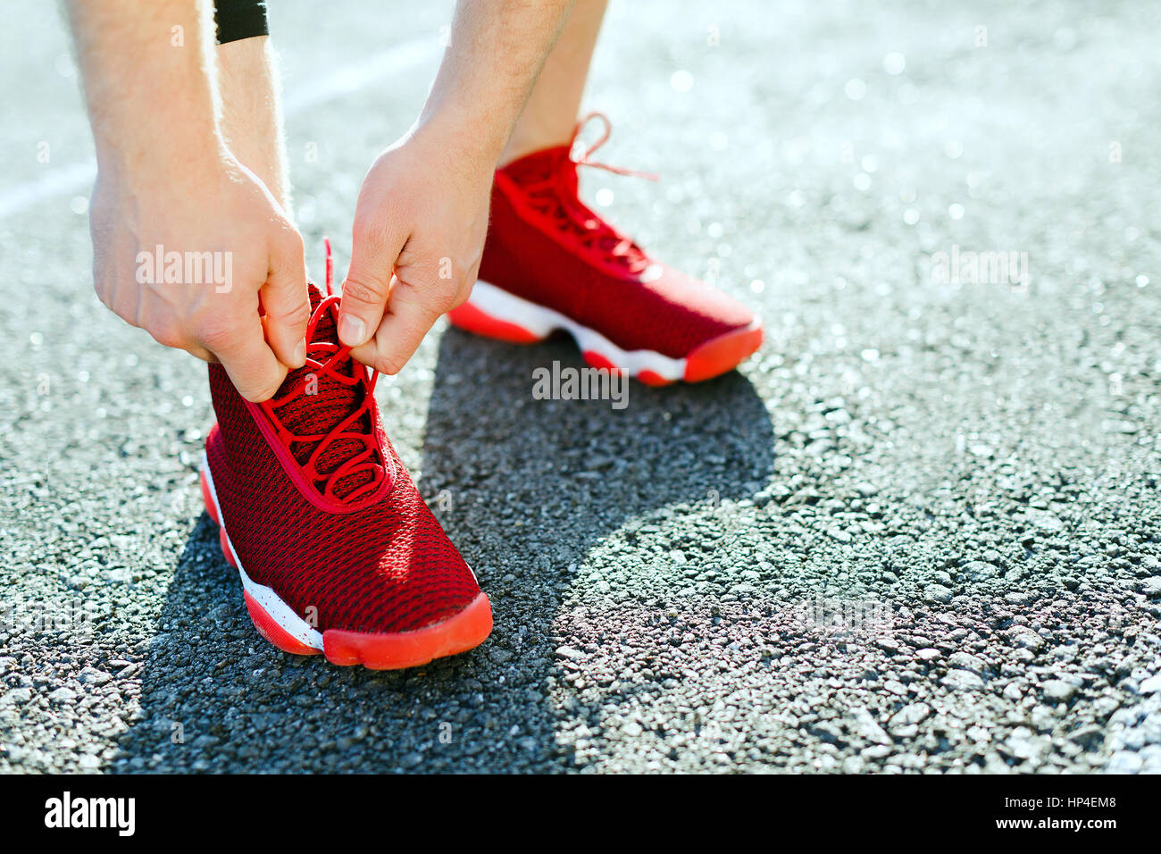 Legs in red sneakers Stock Photo - Alamy