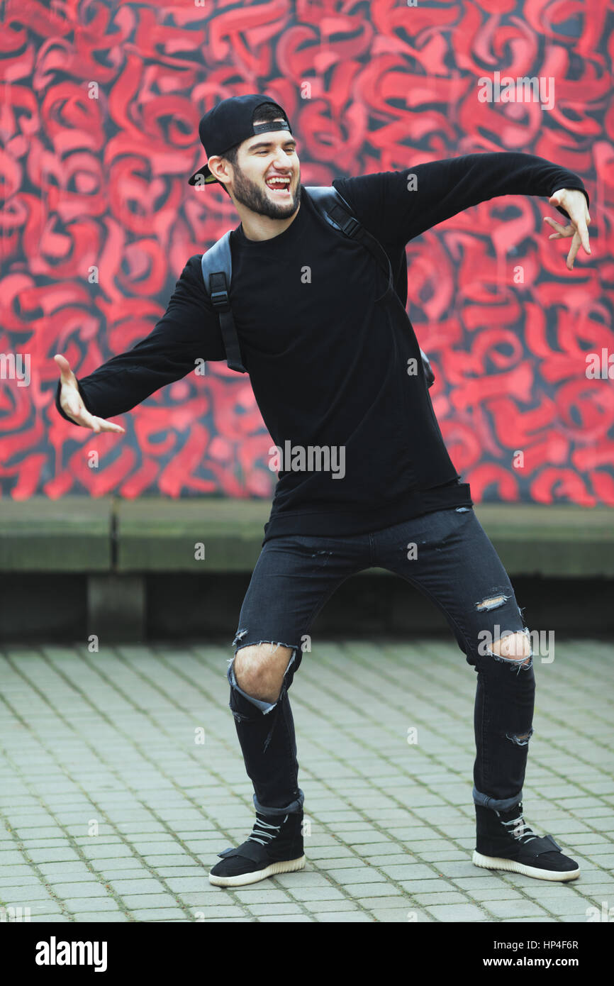 Man near colorful wall Stock Photo - Alamy